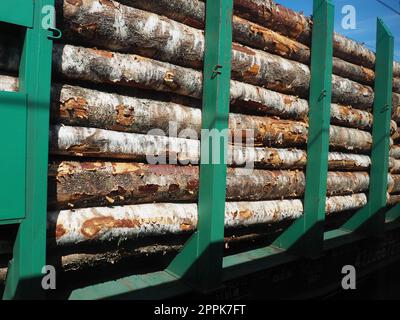cargo timber train. Open train carriage with a bundle of timber for ...