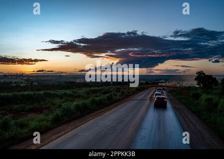 sunset over the road with cars Stock Photo - Alamy