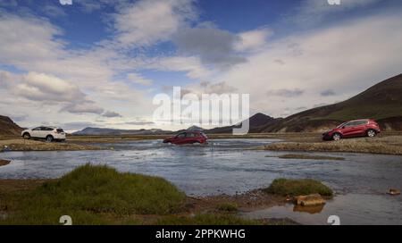 Cars driving across shallow river landscape photo Stock Photo - Alamy