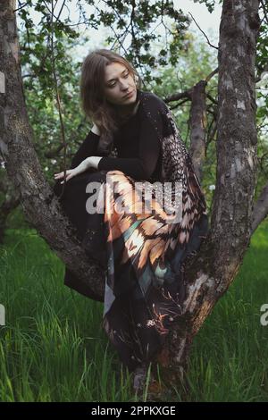 young ukrainian woman in color block clothes looking at camera near ...