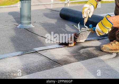 Man Heating and melting bitumen roofing Flat roof installation Stock Photo - Alamy