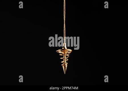 Beautiful golden pendulum with chain on black background. Hypnosis ...