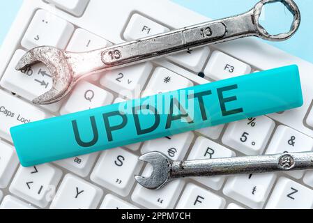 Text sign showing Update. Business photo showcasing by adding new information or making ...