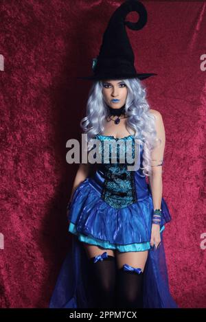 Halloween witch on dark blue background Stock Photo - Alamy