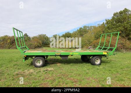 Trailer for transporting hay bales in a meadow Stock Photo - Alamy