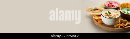 Different kinds of tasty hummuses on white background, top view. Banner ...