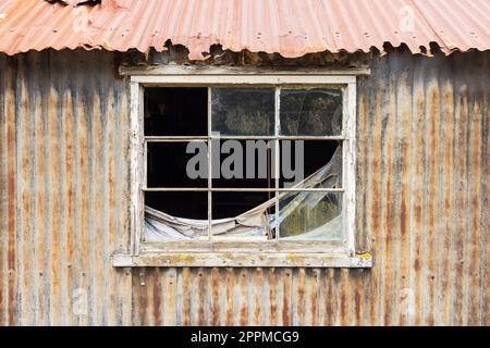 The ruins within an old and decrepit building, with a collapsed wall ...
