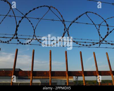 A closeup of a link of a rusty barbed wire fence Stock Photo - Alamy