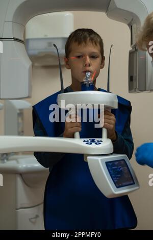 Jaw computed tomography, check up teeth in dental clinic. Little boy ...