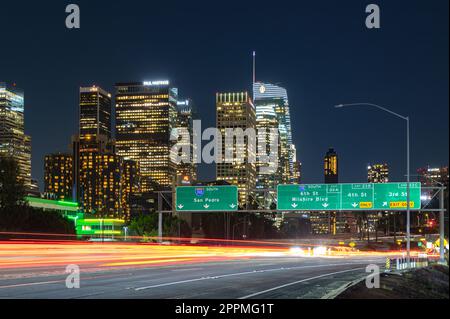 Illuminated skyscrapers and highway at night Los Angeles California ...