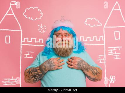 Fat amazed man with beard, tattoos and sunglasses combs himself with a ...