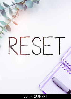 Hand writing sign Reset. Business idea cause device return to its ...