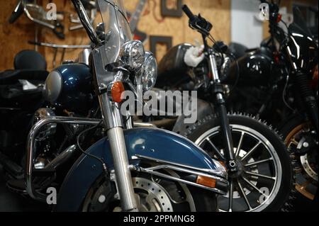 Motorcycles range in garage shop, repaired motorbikes ready for selling ...