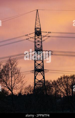 Utility pole during a magnificent sunset electricity Stock Photo - Alamy