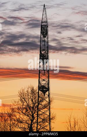 Utility pole during a magnificent sunset electricity Stock Photo - Alamy