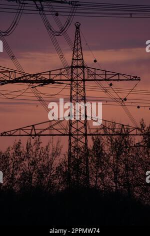 Utility pole during a magnificent sunset electricity Stock Photo - Alamy