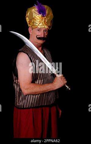 An elder sultan or shiek with a sword isolated over black Stock Photo ...