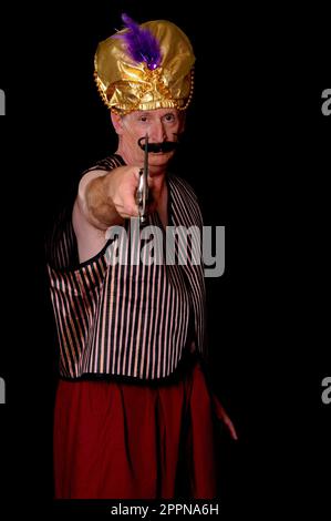 An elder sultan or shiek with a sword isolated over black Stock Photo ...