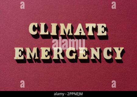 Climate Emergency, words in wooden alphabet letters isolated on blue ...