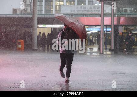 Hong Kong Observatory issues Amber Rainstorm Warning People holding ...