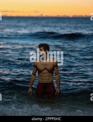 Man wading in the water at Sunset beach in Hawaii Stock Photo - Alamy