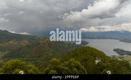 Lake Toba among the mountains with tropical vegetation. Sumatra ...