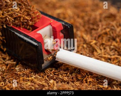 Tobacco and filling machine. Cigarettes and tobacco. Tobacco close-up ...