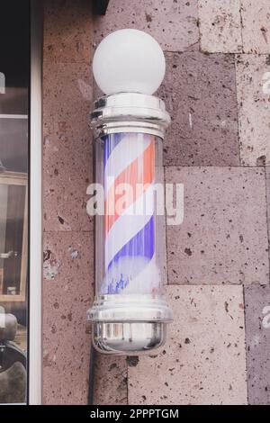 The red and white striped helix of a traditional barbers pole. Fixed to ...