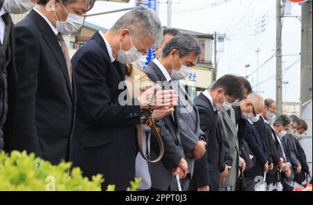 West Japan Railway Company employees mourn for victims near the site of the derailment accident ...