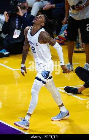 Memphis Grizzlies guard Ja Morant laces his shoes on the bench in the ...