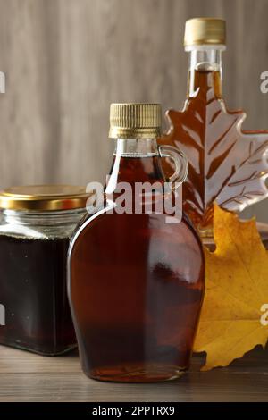 Different bottles of tasty maple syrup on white background Stock Photo ...