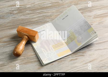 Moldova, Ceadir-Lunga - June 13, 2022: Wooden stamp and open passport ...