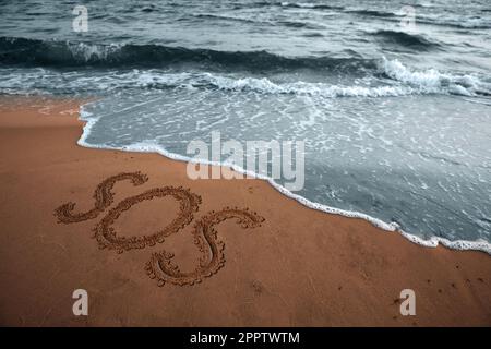 SOS message drawn on sandy beach near sea Stock Photo - Alamy