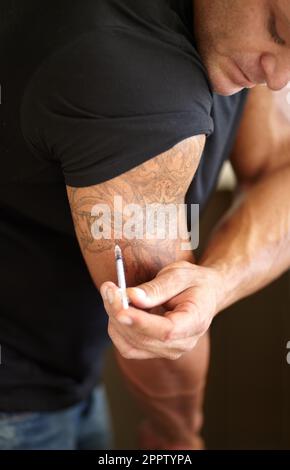 Closeup, steroids and man with needle, drugs or fitness with tattoo ...