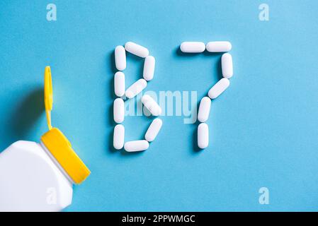 white dietary supplement pills top view on orange background. immune ...