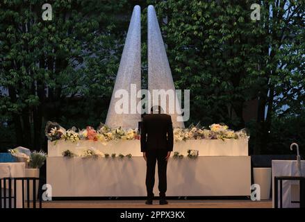 People pray for victims at a memorial facility at the accident site in Amagasaki City, Hyogo ...
