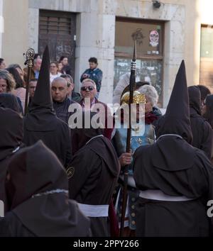 Cofrades in their traditional costumes with capirote, parading through ...