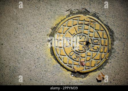 Yellow SoCal Gas pavement cover in the road in Costa Mesa, California ...