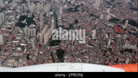 Flying over metropolitan large city of sao paulo, passenger looking ...