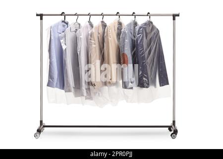 Clothing rack at dry cleaners with suits in plastic covers isolated on ...