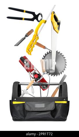 Tools falling into a tool bag on a black background Stock Photo - Alamy