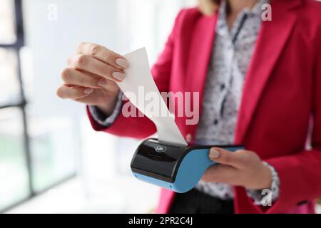 Administrator tears off purchase receipt after e-payment Stock Photo ...