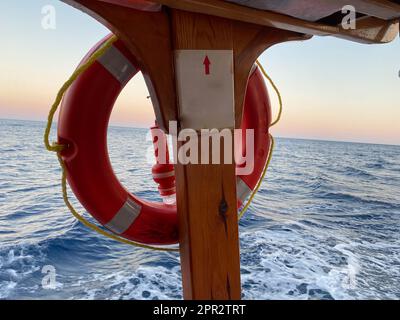 big orange lifebuoy as a rope for the rescue of any swimmers in the sea ...
