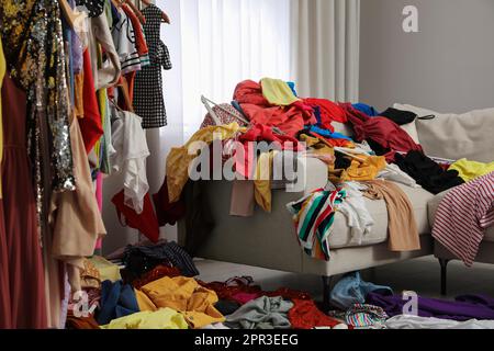 Mess of clothes all over room. Fast fashion Stock Photo - Alamy