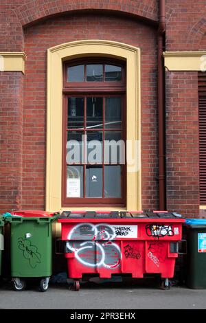 Waste bins beside brick wall, Wellington, North Island, New Zealand ...