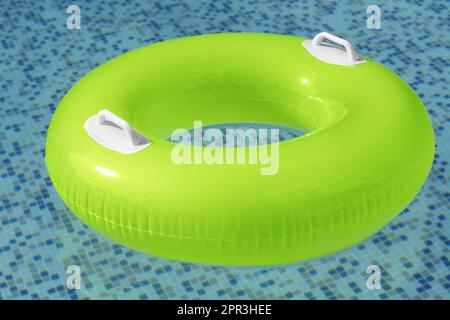 Light green inflatable ring floating in swimming pool Stock Photo - Alamy