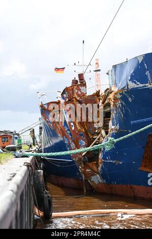 Emden, Germany. 26th Apr, 2023. The heavily damaged coaster lies in ...