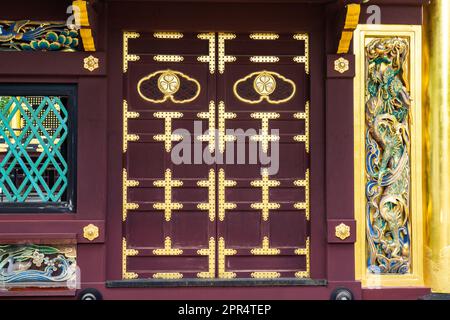 The ornate golden Karamon gate with the ascending and descending dragon ...