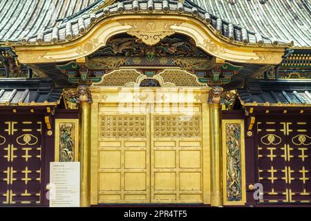 The ornate golden Karamon gate with the ascending and descending dragon ...