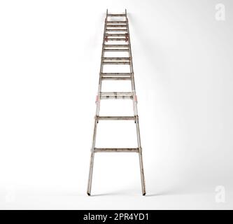 A regular metal aluminium extendable step ladder leaning against a ...